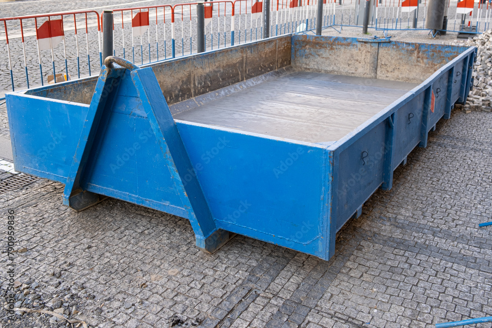 Empty blue waste container A steel industrial with on the street, urban ...