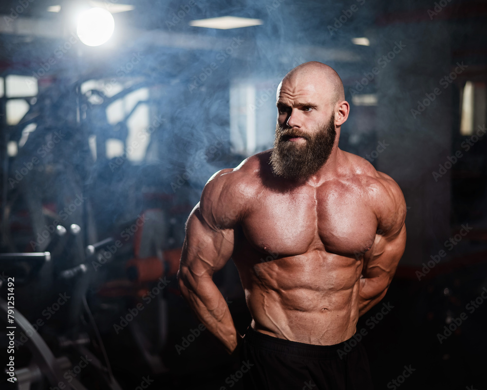 Muscular bald man posing shirtless. Bodybuilder showing off his shape ...