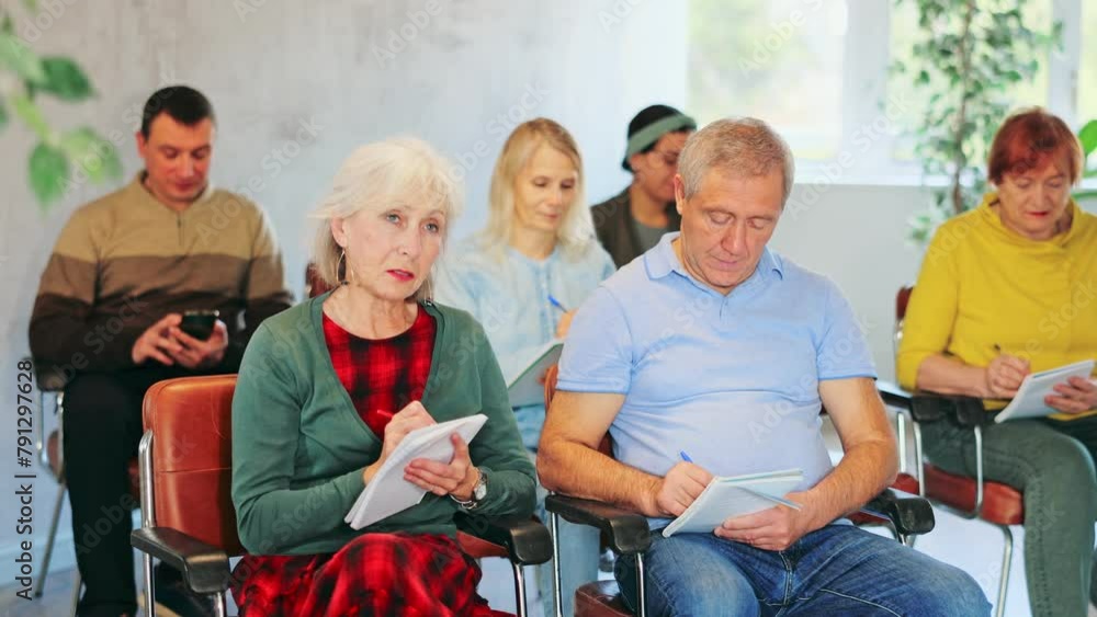Positive interested elderly people listening attentively and taking ...