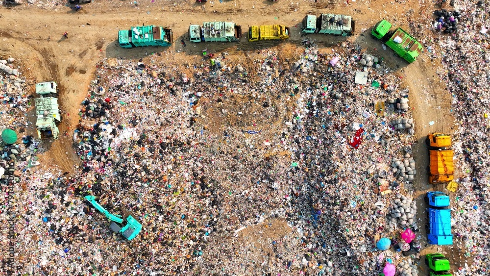 The sprawling expanse of a landfill: a grim tableau of waste heaps ...