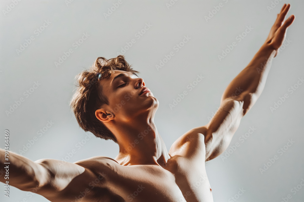 Dynamic portrait of shirtless male dancer posing with arms extended ...