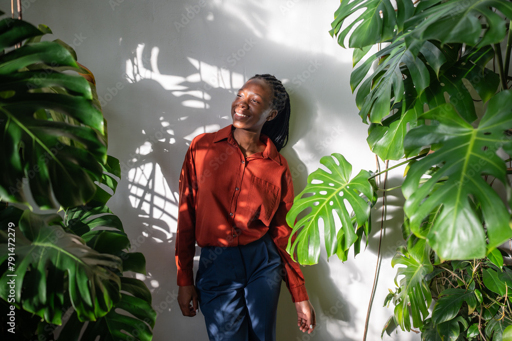 Relaxed African American woman stand in home garden enjoying ...