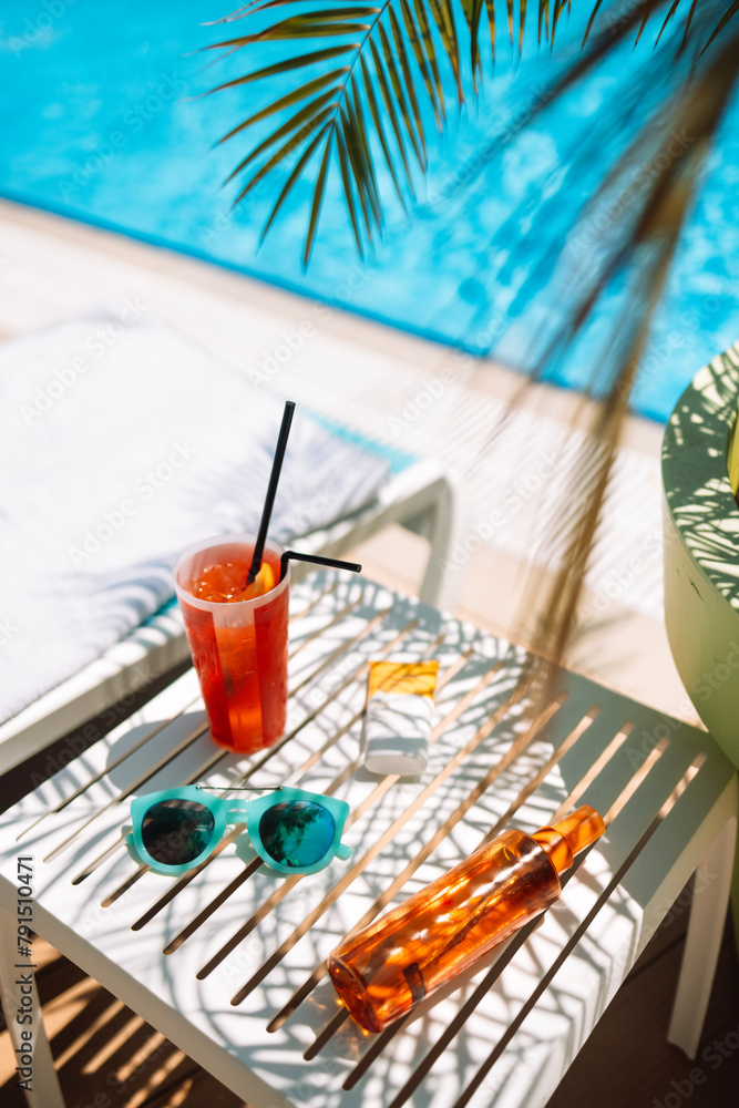 Sunscreens, sunglasses and a delicious chilled cocktail on the pool ...