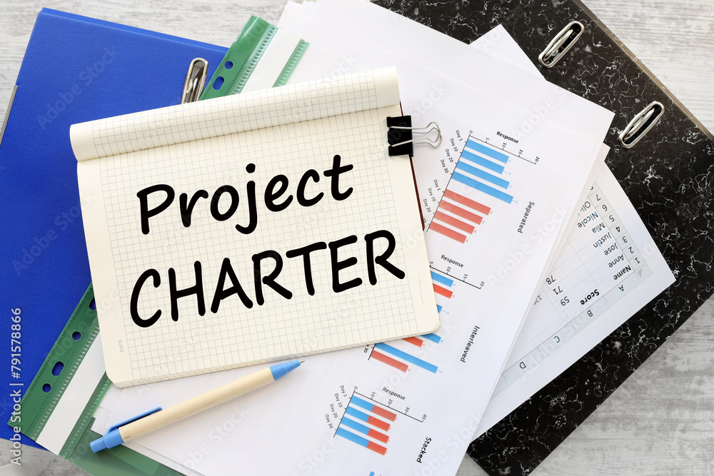 PROJECT CHARTER work desk blue folder blue financial charts. text on a ...