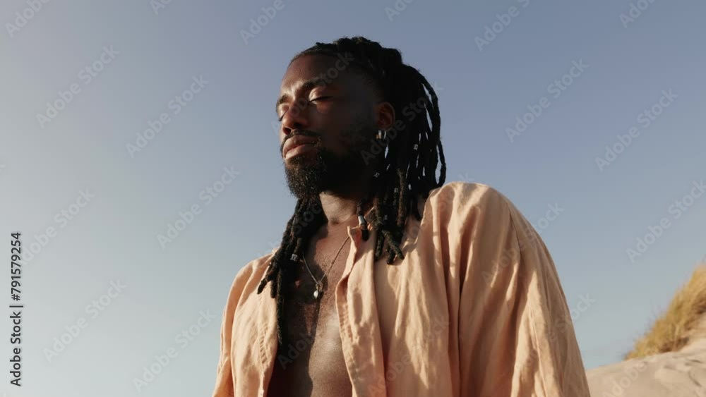 Tranquil black man with dreadlocks practicing deep breathing exercises ...
