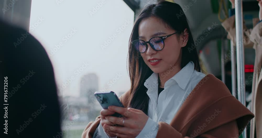 Cute Asian girl in stylish outfit taking bus or train to reach location ...