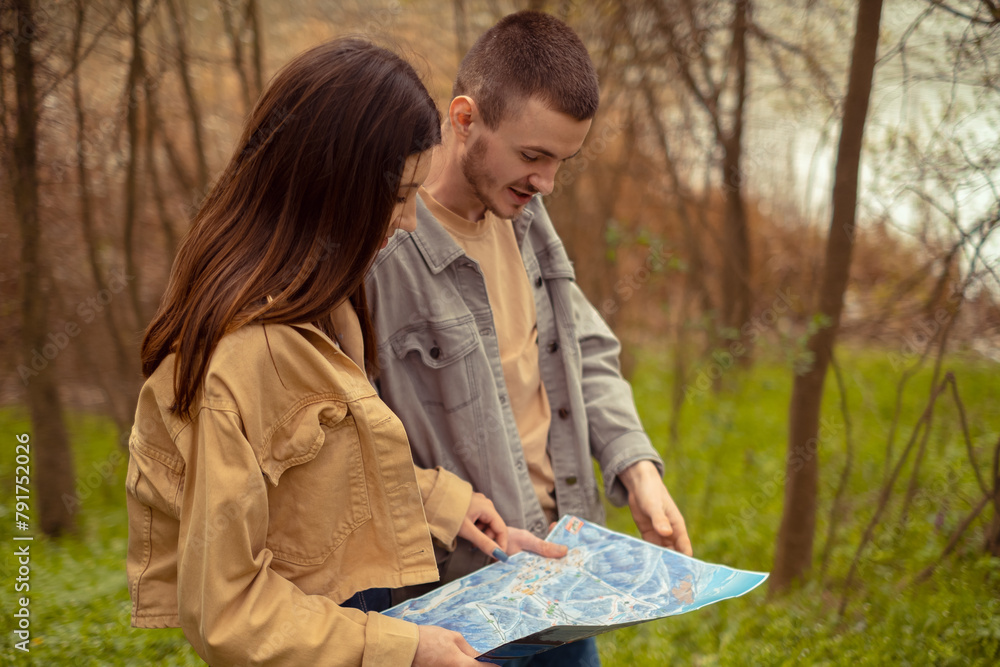 Travelers with a map in hand in forested terrain. Tours and tour ...