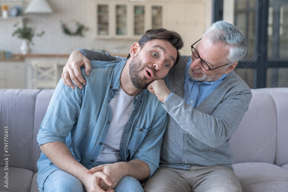 Happy cheerful funny family moment. Old elderly senior father touching ...