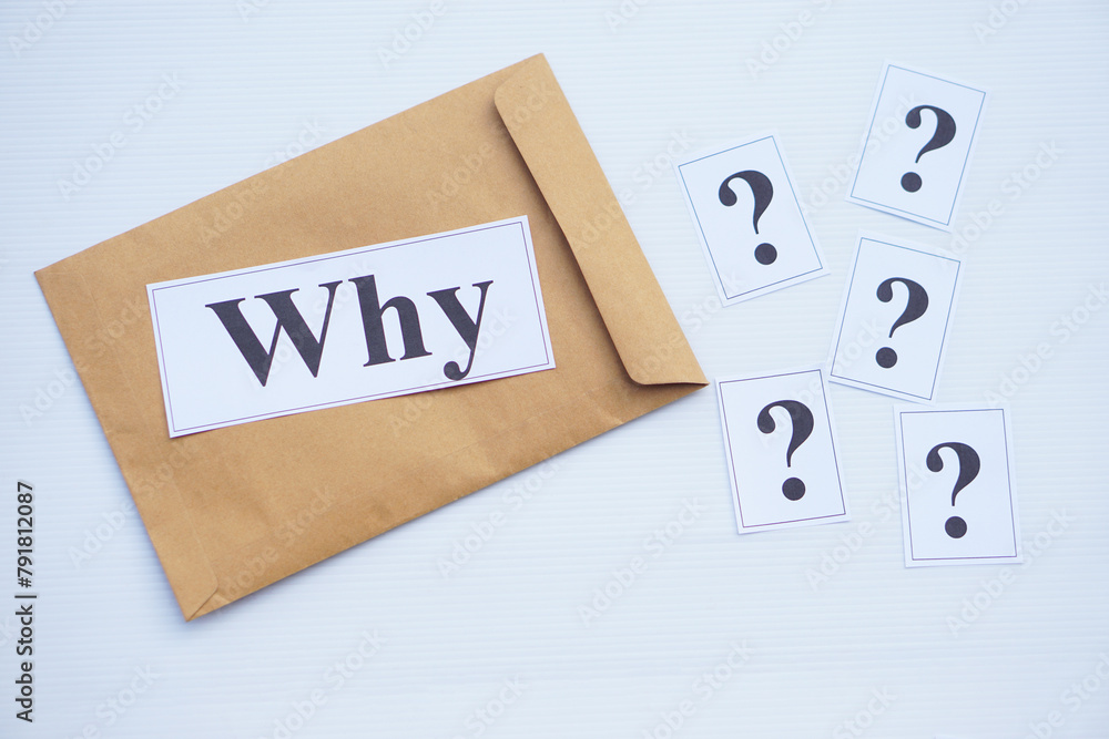 Brown envelope and printed question word Why and question marks ...