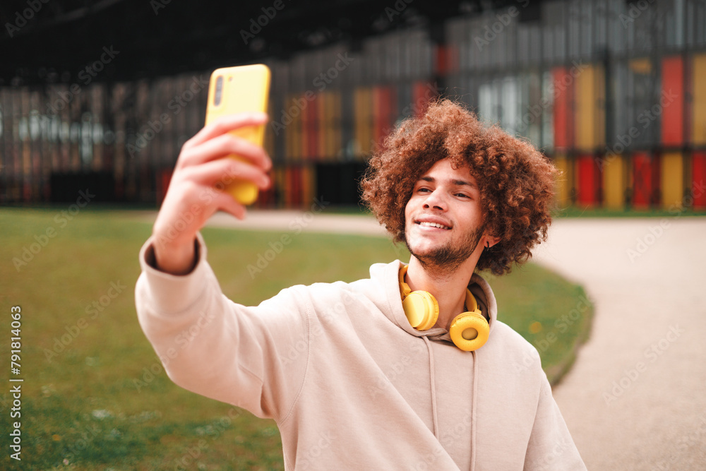 Curly z generation male taking selfie in modern park. Stock Photo ...
