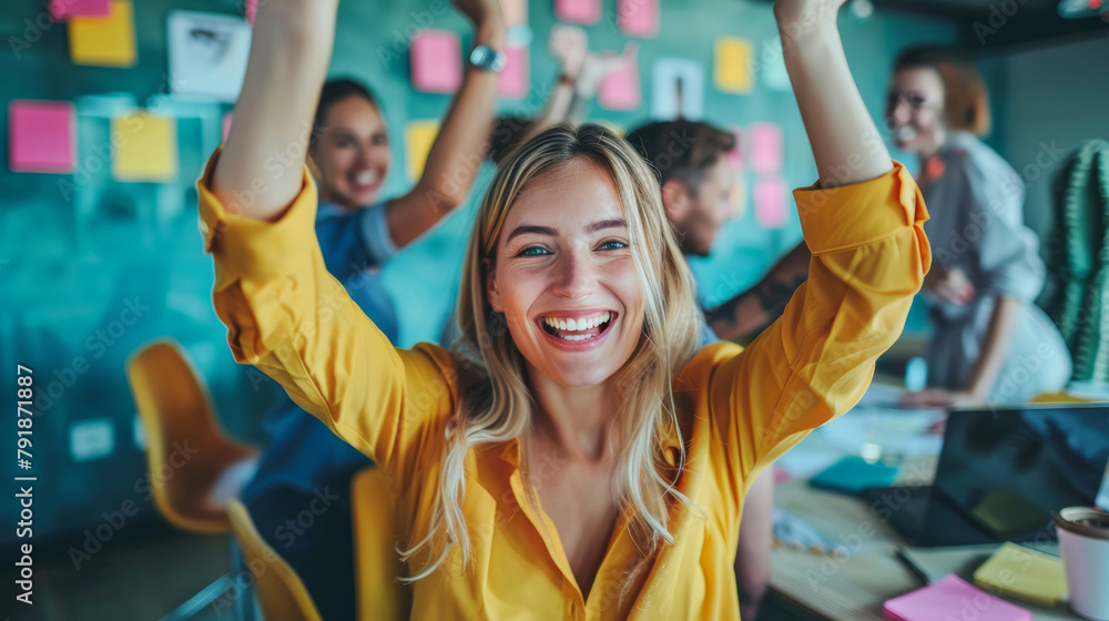 Joyful business team with female leader celebrating success in modern ...