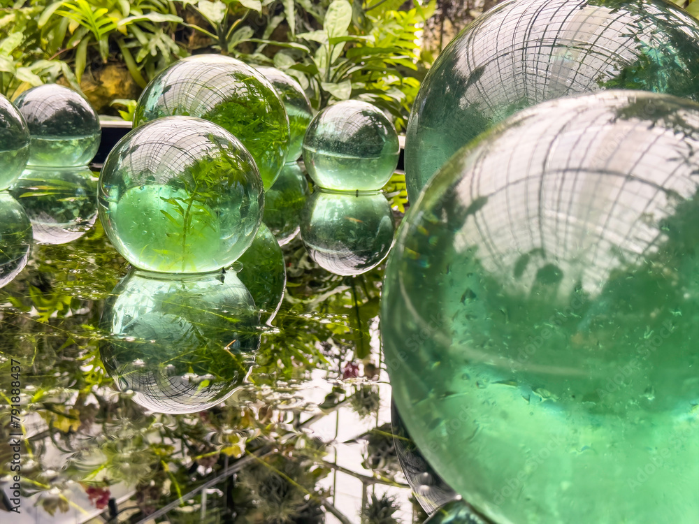 Glass spheres on the surface of an artificial pool that reflect the ...