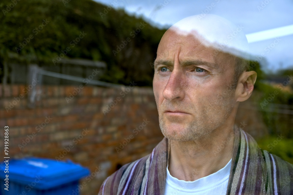 HDR Male midlife crisis. Male actor looks out of house window depressed ...