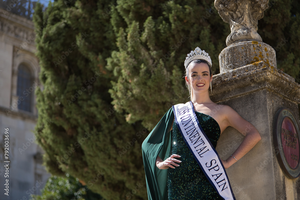 Young, pretty, blonde woman in green party dress with sequins, diamond ...