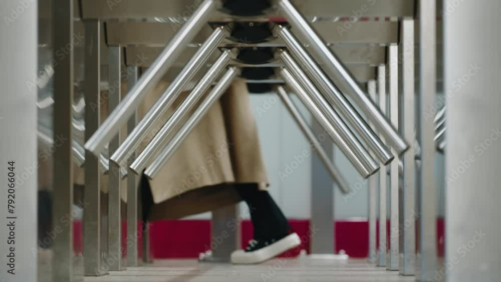 Low angle view unrecognizable female passenger going through steel ...