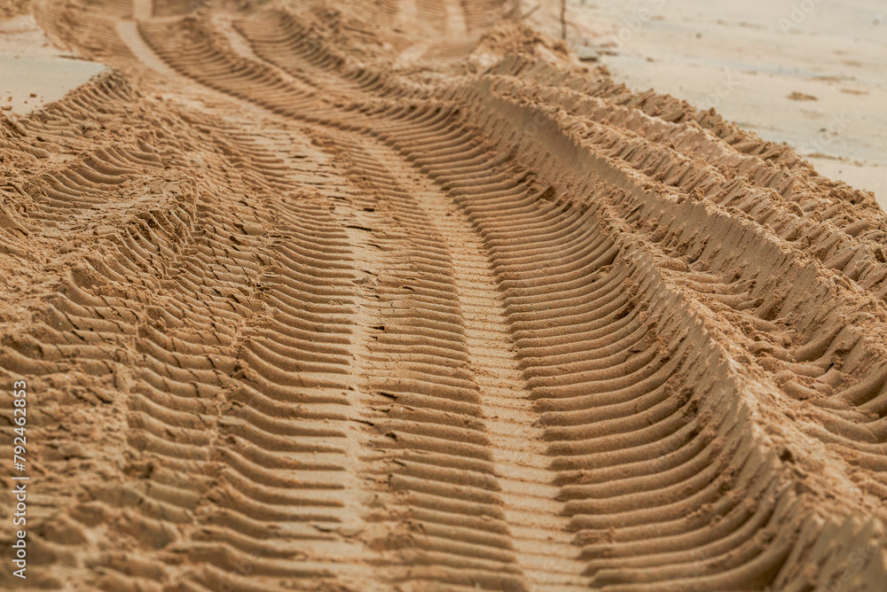 The wheel ruts of construction vehicles on the beach at the seaside ...