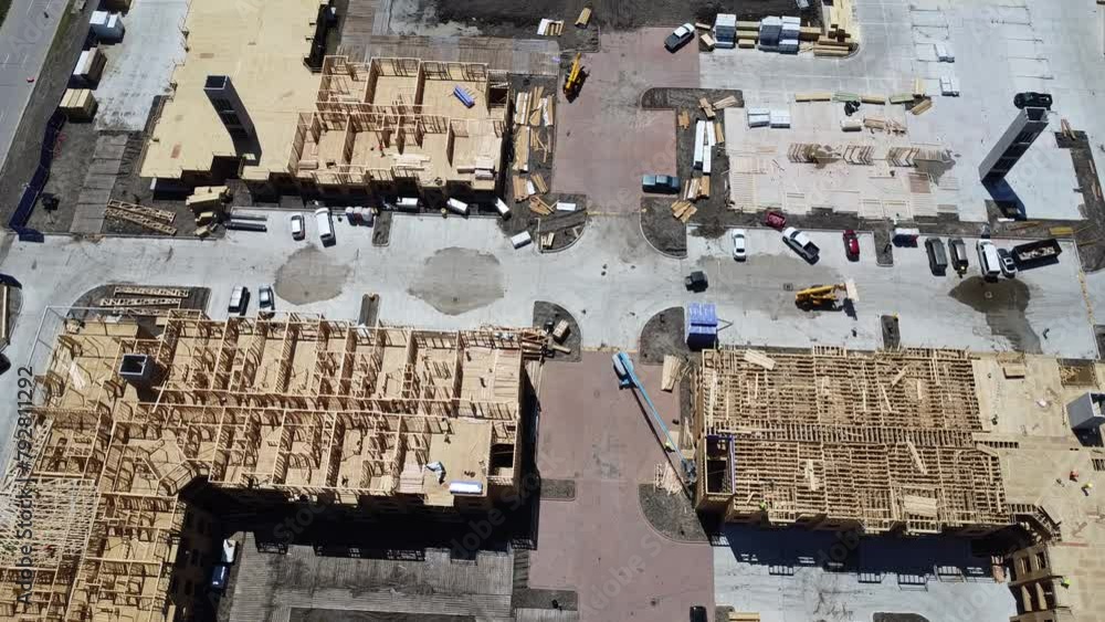 Heavy construction equipment, machine and workers at large multi-story ...