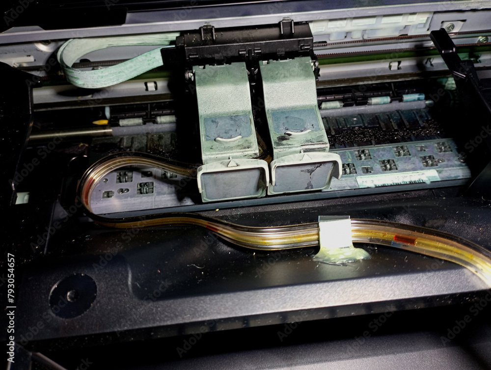 The printer cover is open and the cartridges on the print carriage are ...