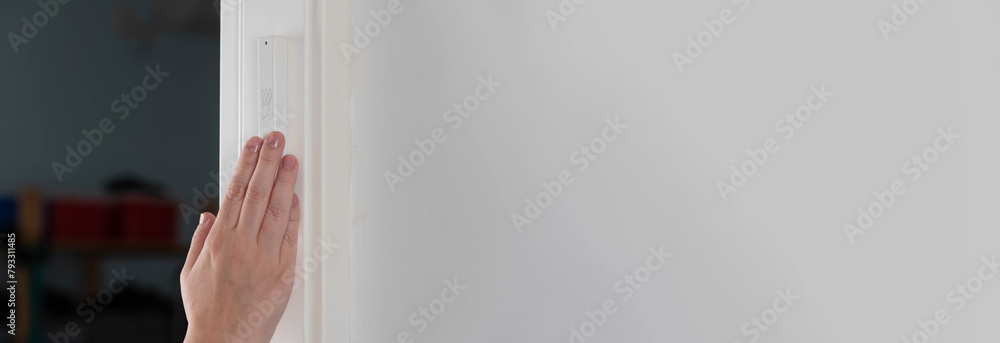 Hand gently touches the Jewish mezuzah on the doorpost, a prayer for ...