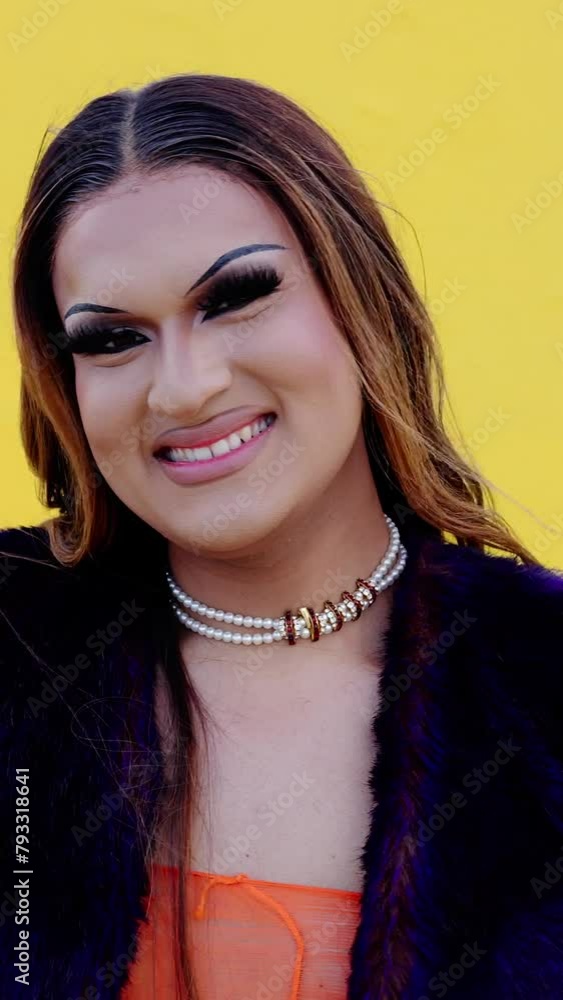 Vertical portrait of isolated LGBTQ young drag queen person smiling at ...