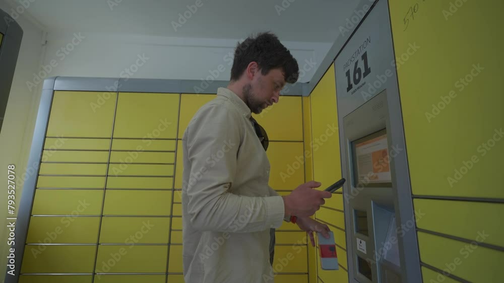 Male customer using self-service automated delivery terminal to send ...
