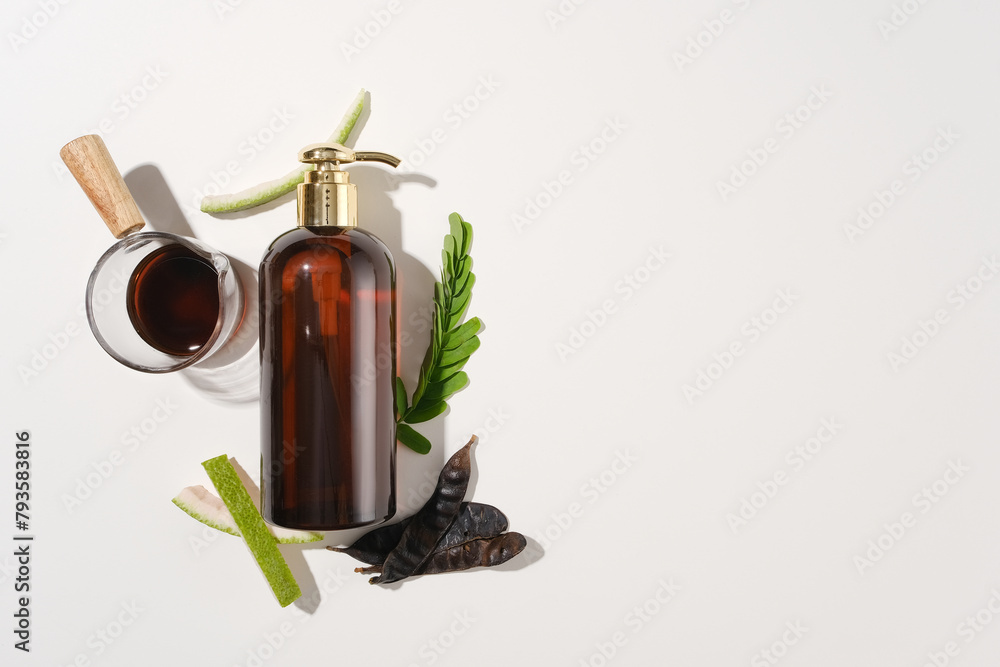 Front view at white texture with a unlabeled bottle, black locust seed ...