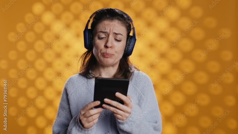 Voice actor frowns while reading ebook, portraying character, studio ...