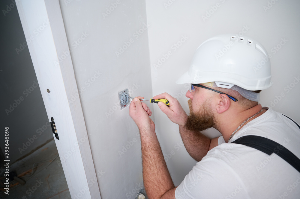 Crop view of electrician installing electric socket using screwdriver ...