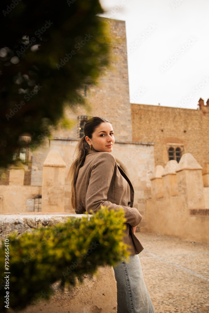 Girl posing next to the entrance of a medieval castle in Perpignan ...