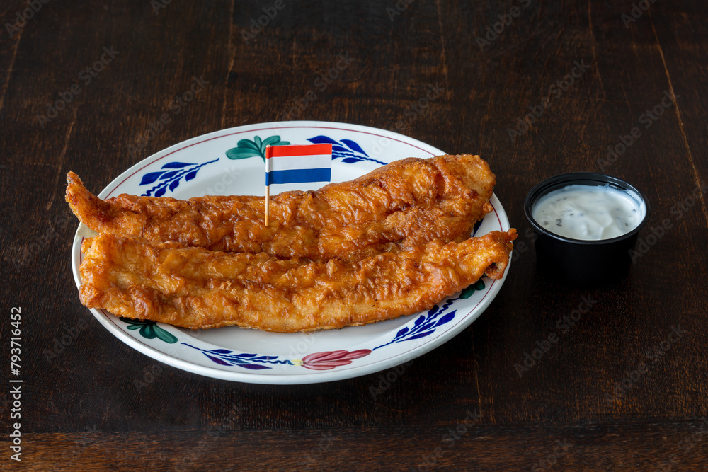 Lekkerbek with sauce on the plate decorated with dutch flag, deep fried ...