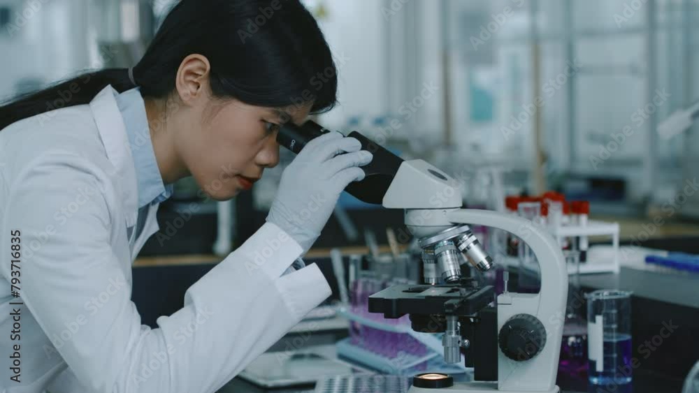 Medium side shot of young Asian female scientist in white coat and ...