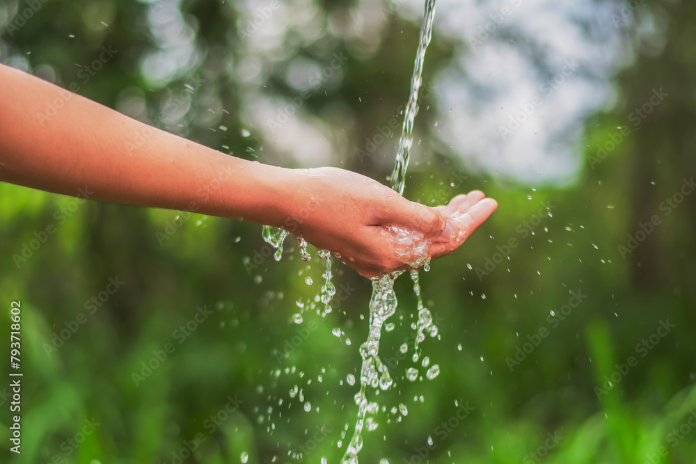 water pouring flow on woman hand on nature background Stock Photo ...