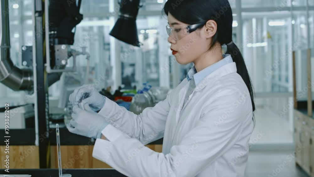 Medium close-up tilting footage of busy Chinese female laboratory ...
