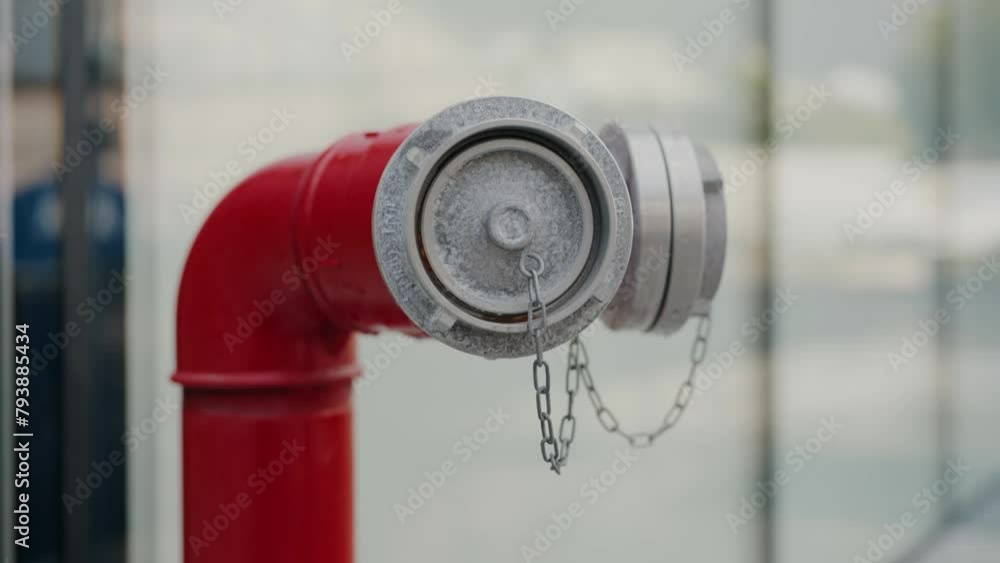 A detailed image of a red fire hydrant equipped with a dust cap and ...