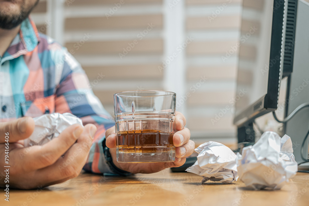 Drunk and frustrated man in the office while working with pc, sitting ...