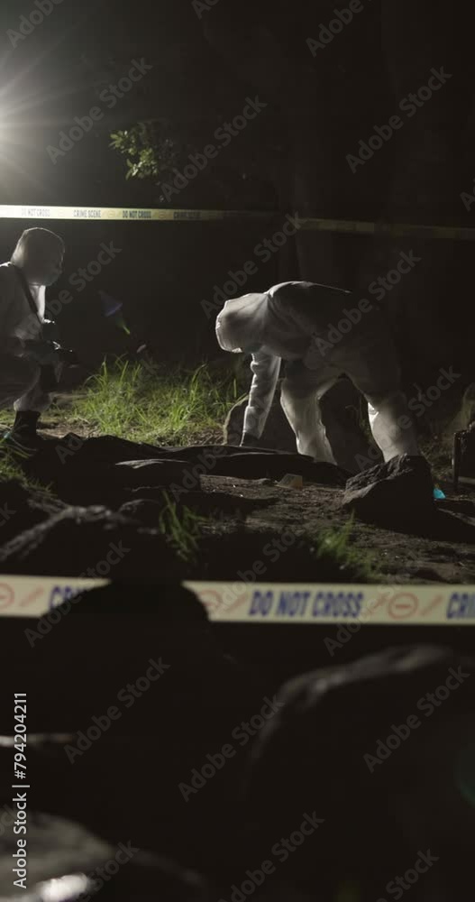 Crime scene, evidence and mystery with forensic team outdoor at night ...