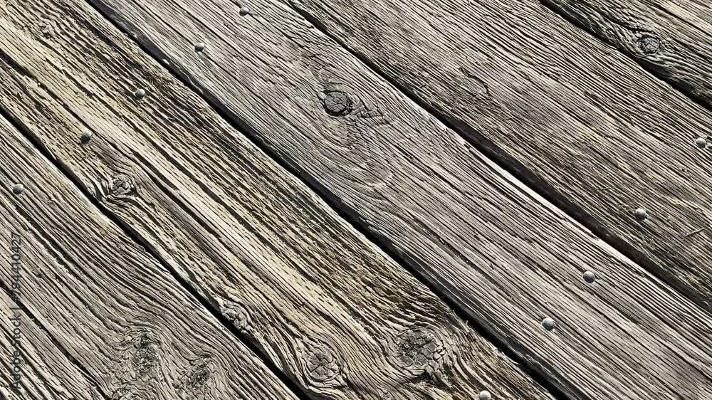 a wooden plank walkway bridge wood boardwalk panning motion moving ...