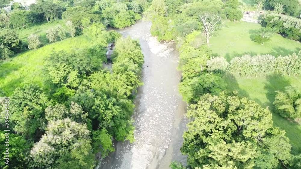Beautiful highway surrounded by farms and green pastures. Nice river on ...