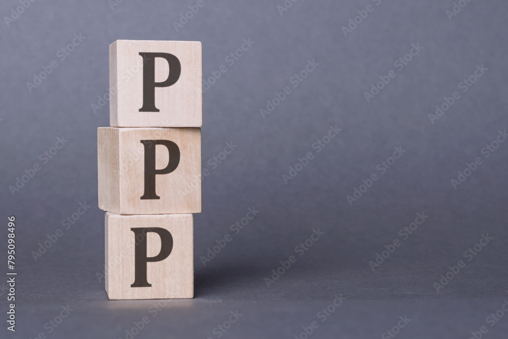Stack of wooden blocks forming the acronym PPP, representing Purchasing ...