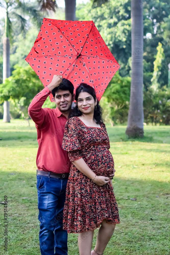 Indian couple posing for Maternity shoot pose for welcoming new born ...