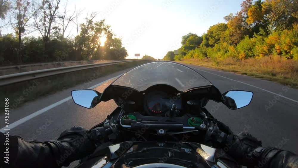 Point of view of motorcyclist driving motorbike at highway with sun ...
