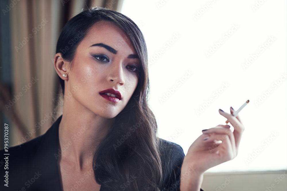 Woman, cigarette and thinking by window in home for decision, memory or relax with mystery ...