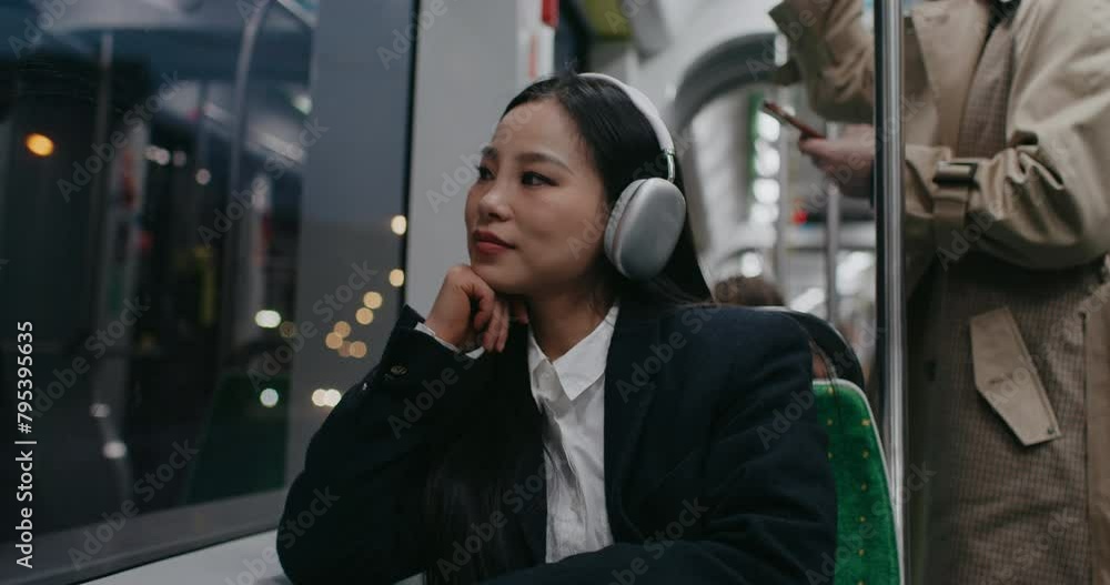Cute Asian girl enjoying night city. Sitting next to window of fast ...