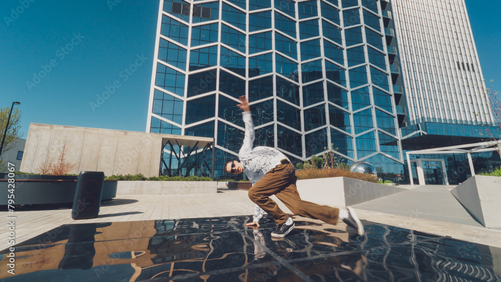 Outdoor Scene Capturing A Young Male Breakdancer Performing An ...