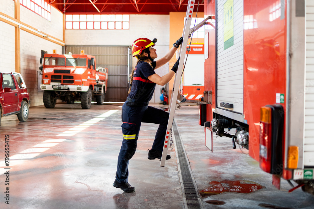 A senior Caucasian woman works as a firefighter dressed in a uniform ...