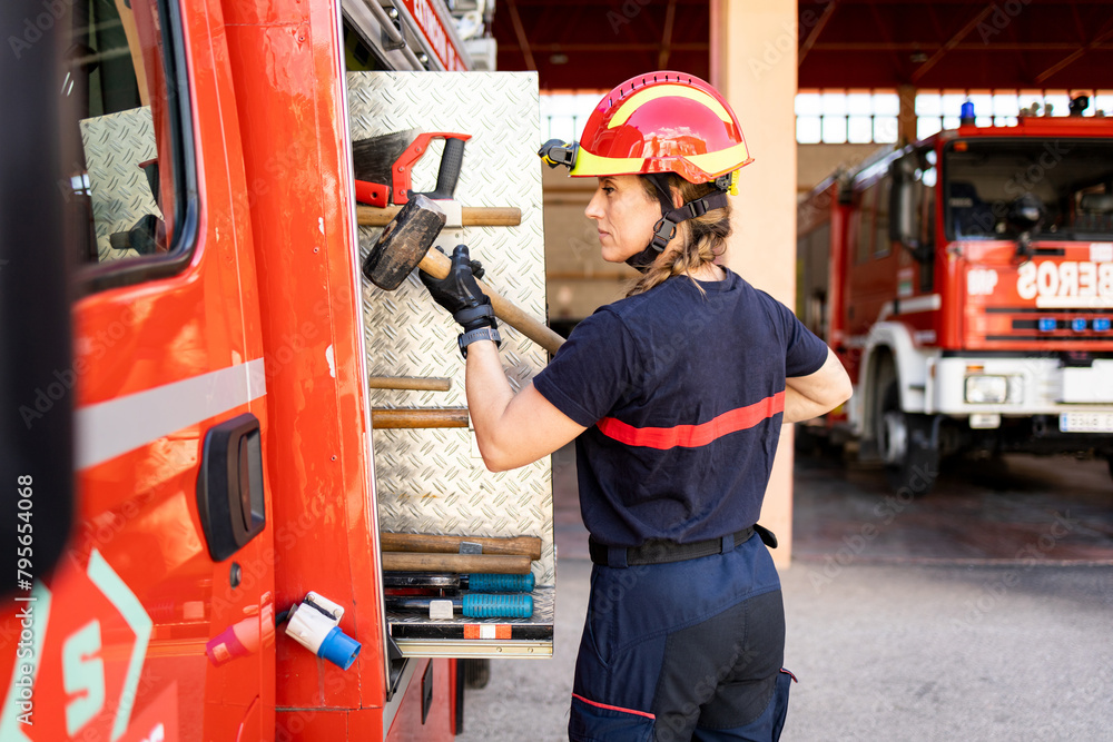 A senior Caucasian woman works as a firefighter dressed in a uniform ...