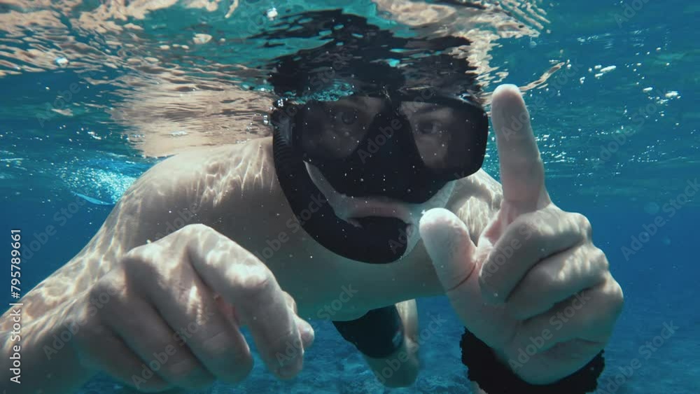 Funny male person wearing snorkel and mask dancing underwater. Happy ...