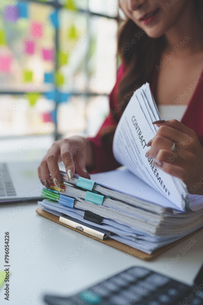 Businesswoman working in piles of paper files Data graph document to ...