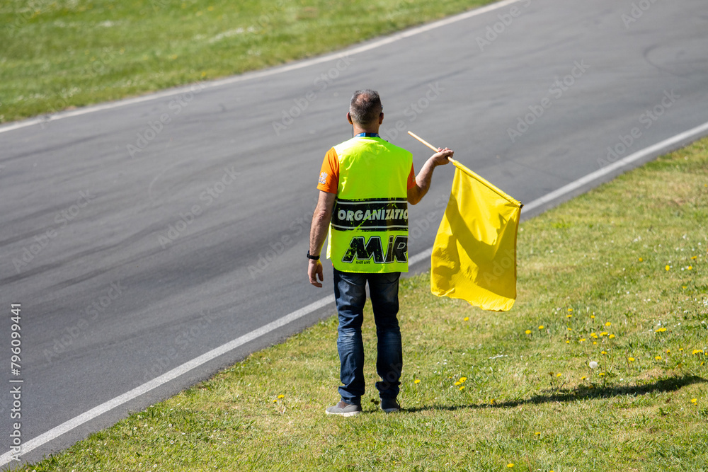 France, 14 April 2024: Motorsport race official holding caution flag on ...