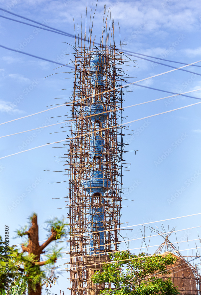 Repairing a mosque using traditional african bamboo scaffolding ...